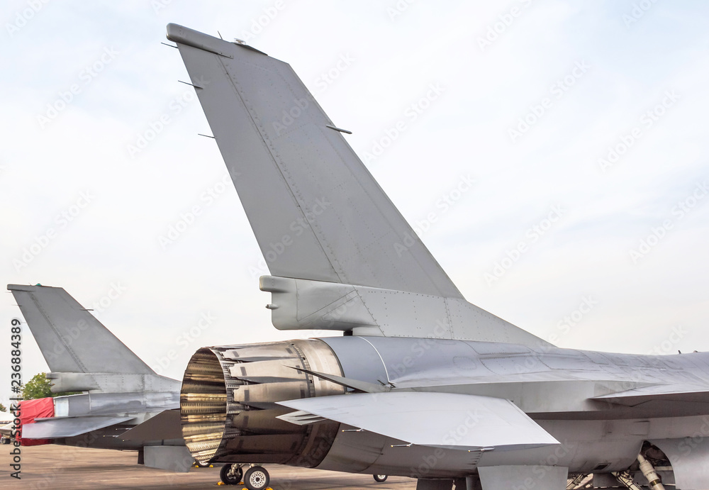 Close up exhaust and tail fin side of fighting military fighter jet ...