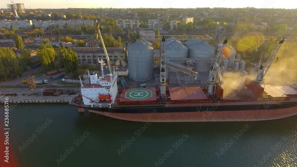 Aerial view of big grain elevators on the sea. Loading of grain on a ...
