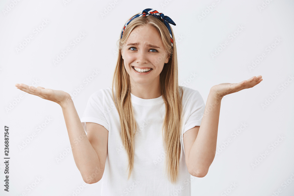 Studio shot of careless calm and carefree young woman with blond hair ...