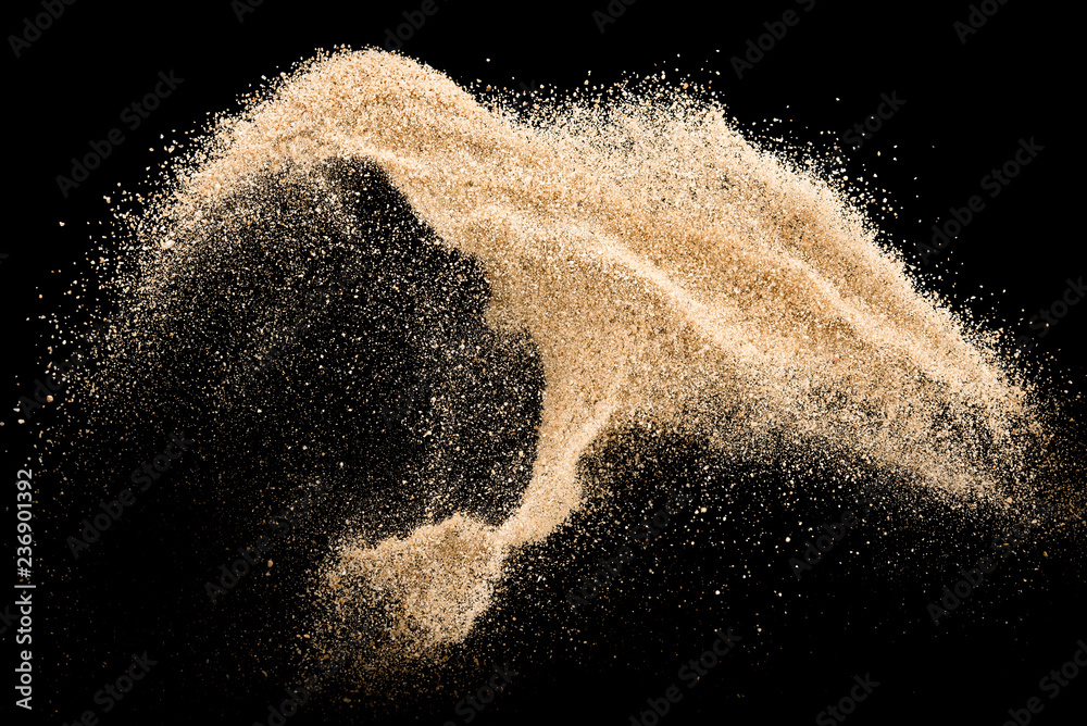 Sand flying explosion isolated on black background ,throwing freeze ...