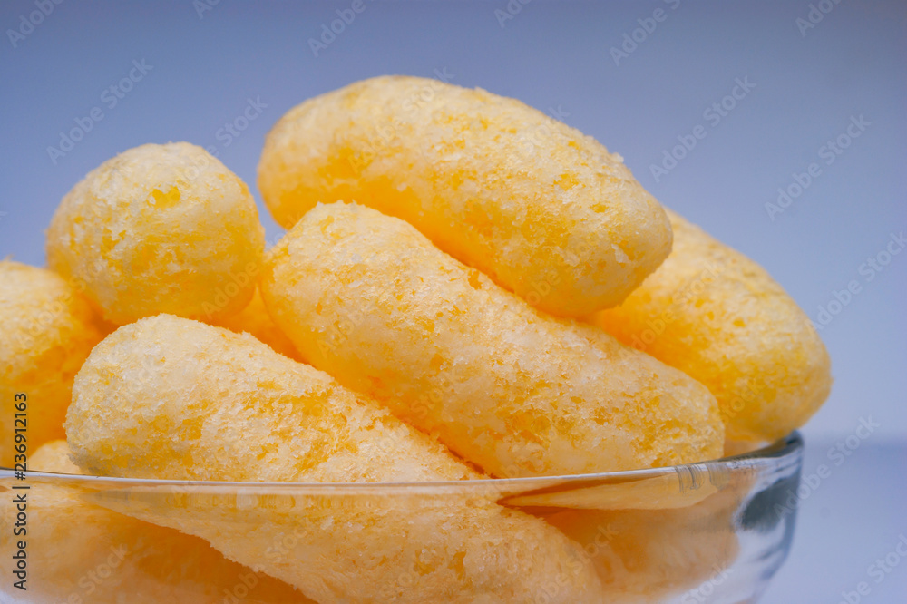 Zoomed Corn Puffs in a Glass Bowl. Crunchy Flavored Puffed Snacks ...