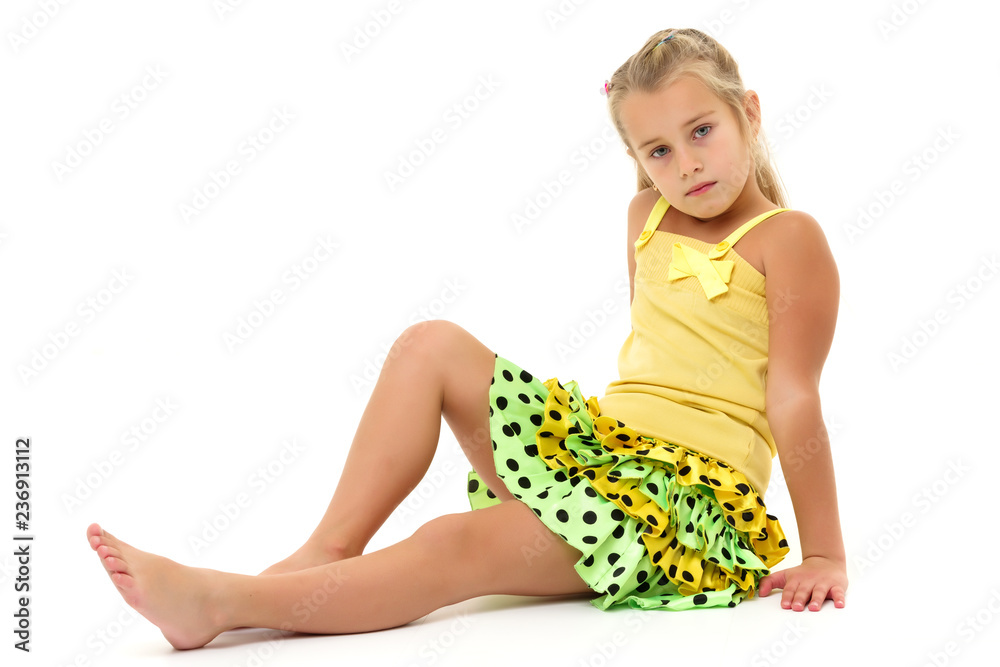 Little girl is sitting on the floor. Stock Photo | Adobe Stock