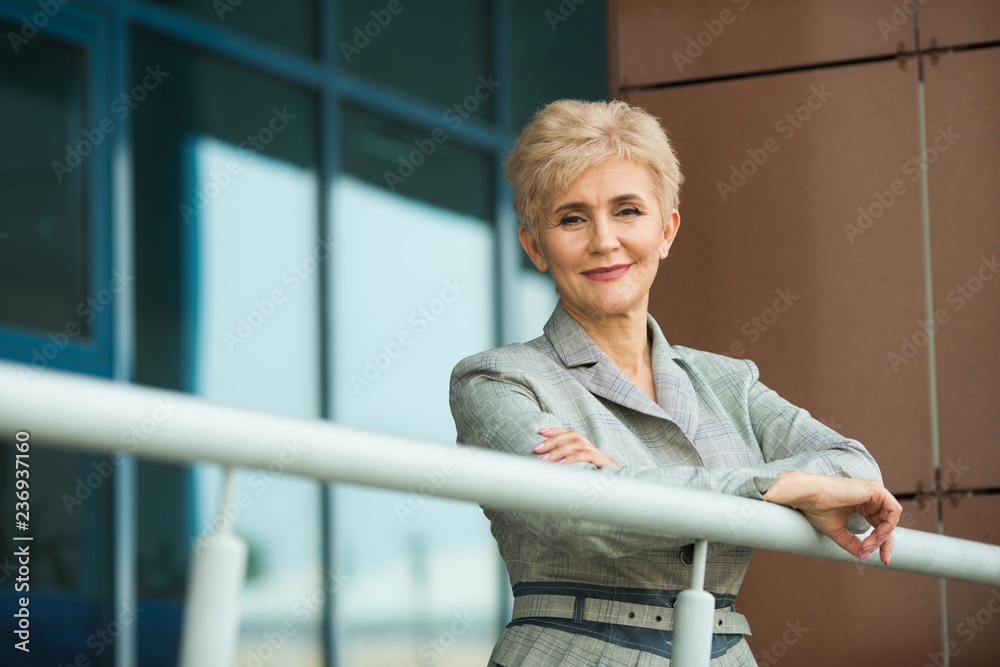 stylish modern woman with a short haircut in a gray suit against the ...
