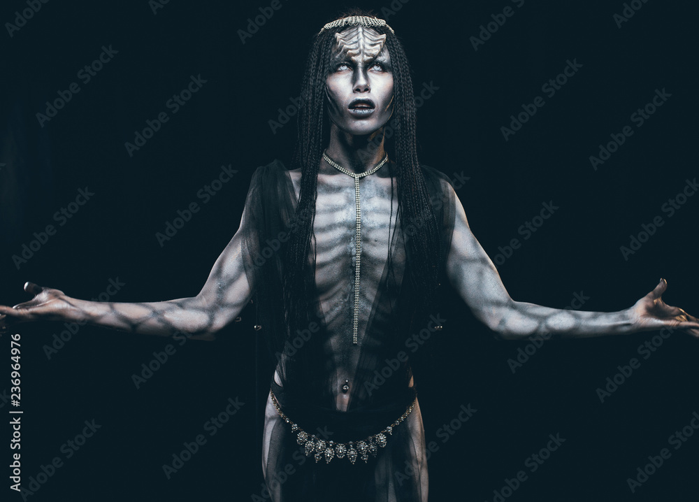 A young woman in the image of a humanoid and extraterrestrial alien ...