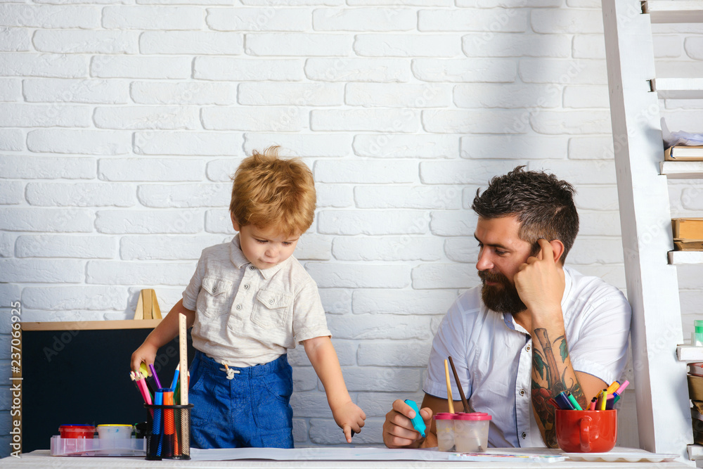 School, creative education. Drawing family, father looks how son draws ...