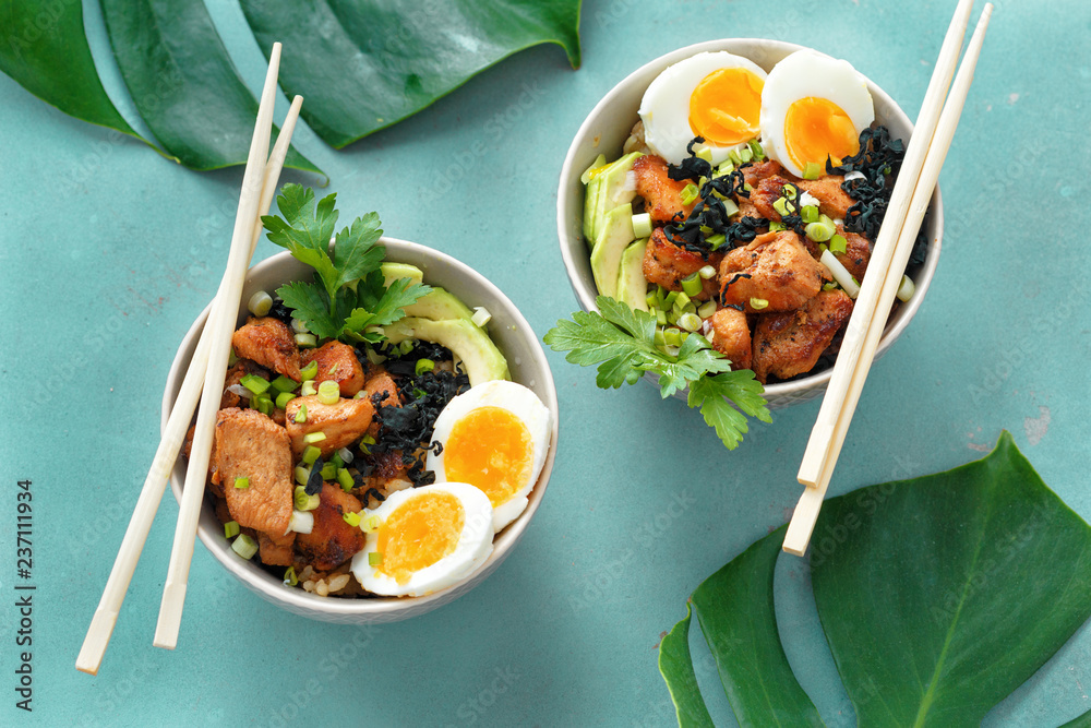 Two poke bowl fried rice chicken fillet eggs top view Asian food Stock ...
