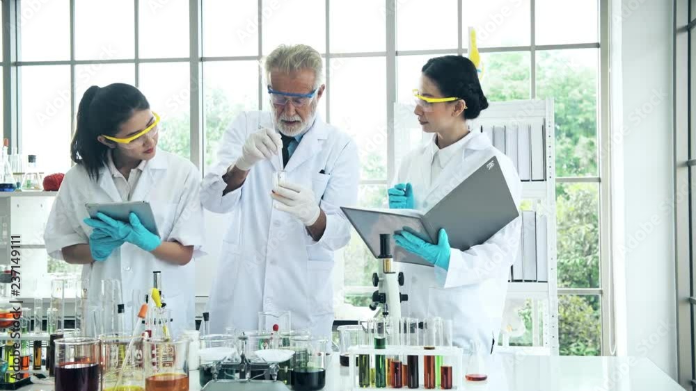 Group of chemists working in a lab. Young asian female chemists with ... Group of chemists working in a lab. Young asian female chemists with ...