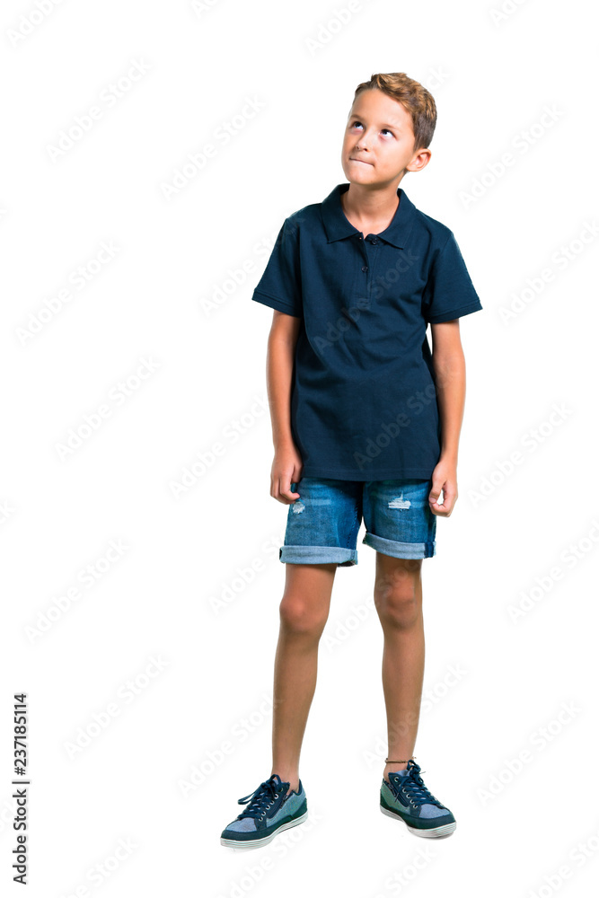 Full body of Little boy having doubts and with confuse face expression ...