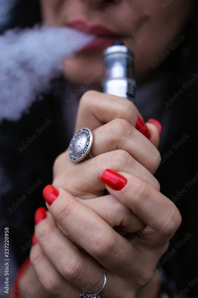 Caucasian woman with red nails manicure and antique ring on finger ...