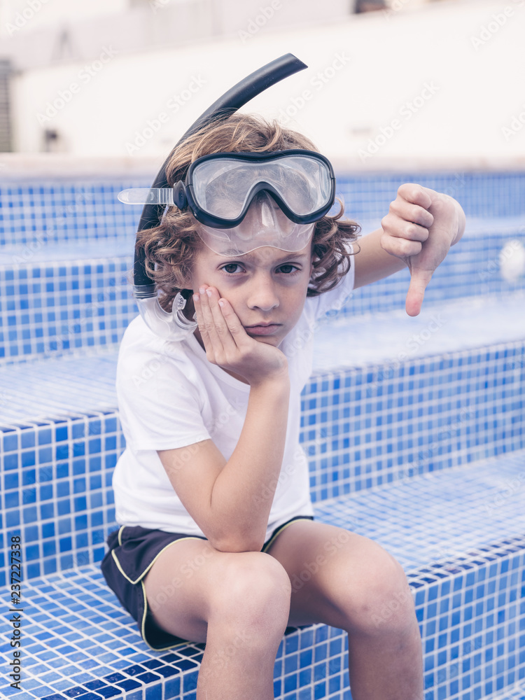 Sad boy in diving equipment n steps of pool Stock Photo | Adobe Stock