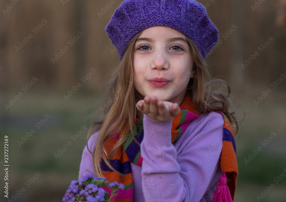 Little cute girl giving an air kiss. Adorable child blowing air kiss ...