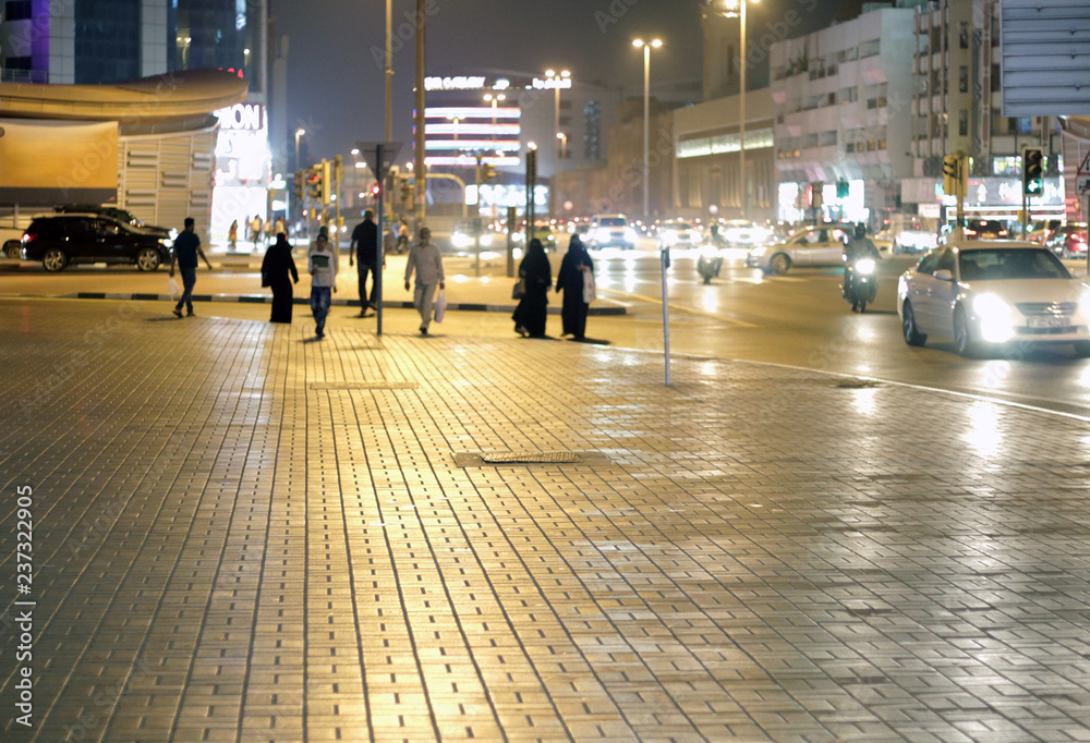 People Walking On The Street At Night