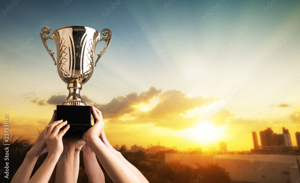 Winning team raise trophy cup with background of sky of light ray Stock ... Winning team raise trophy cup with background of sky of light ray Stock ...