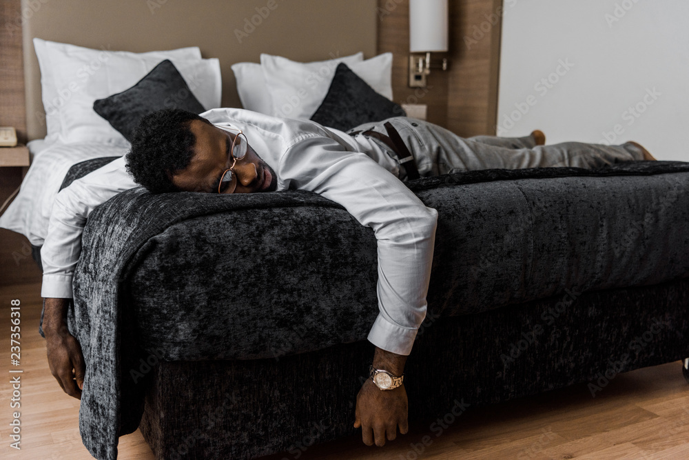 exhausted african american man sleeping on bed in hotel room Stock ... exhausted african american man sleeping on bed in hotel room Stock ...