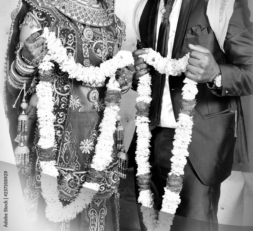 The bride and groom at the Indian wedding garlands or Jaimala ceremony ...