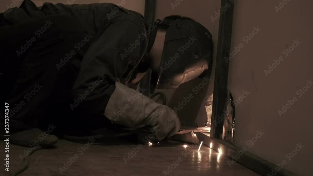 Welder Worker Performs Jump Welding. Worker Welder Performs Arc-Welding ...