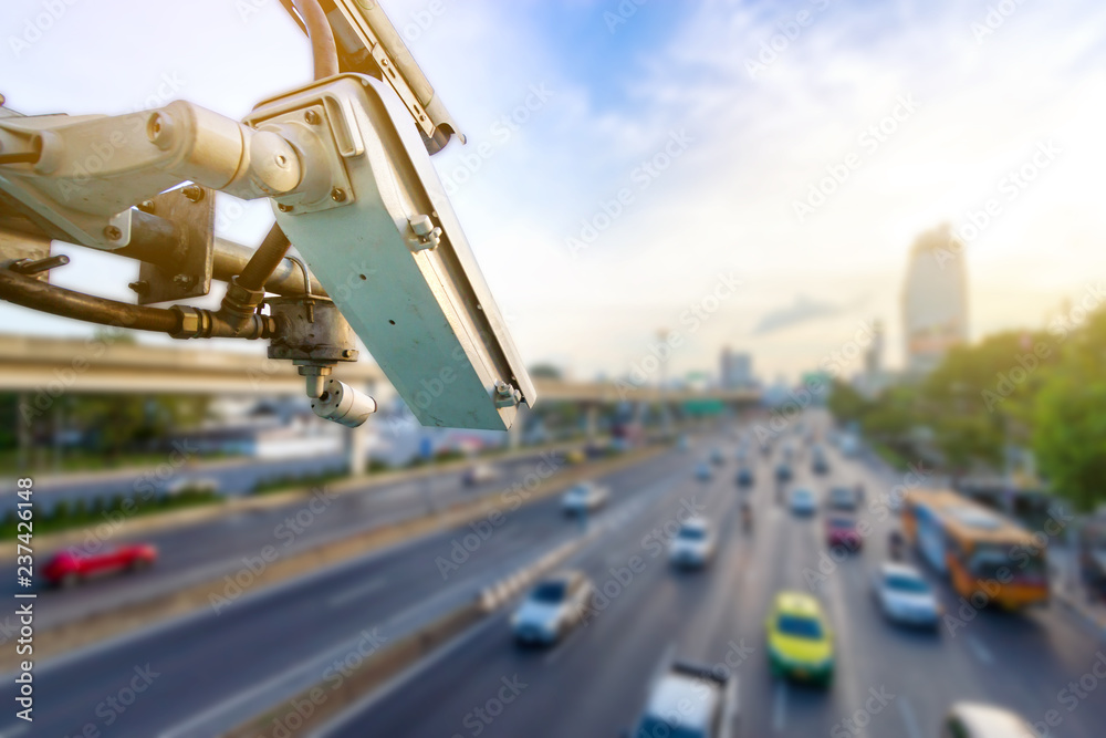 A Security CCTV camera has focus and recording a lot of car on the road ...