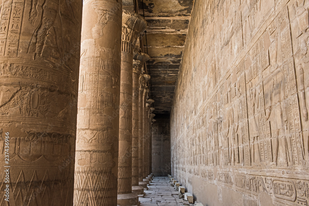 Hieroglyphic carvings on an ancient egyptian temple wall with columns ...