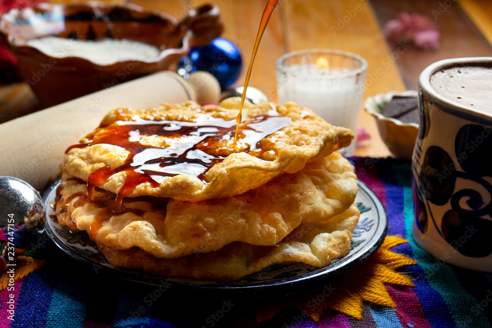 Mexican buñuelos with piloncillo syrup Stock Photo | Adobe Stock