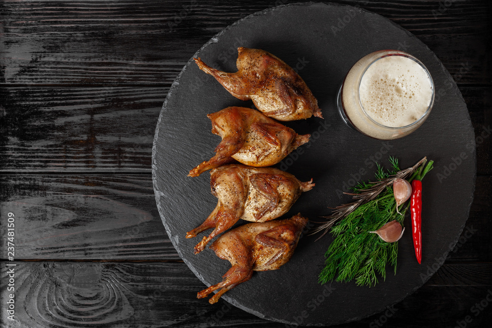 Fried quails on black table Stock Photo | Adobe Stock