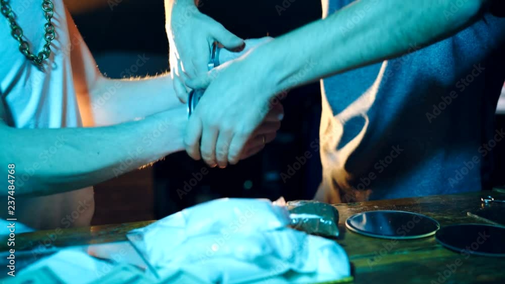 Police officer arresting drug dealer with handcuffs. Close up. Illegal ...