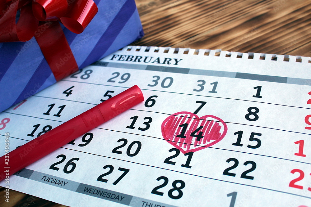 On the table is a sheet of a calendar where Valentine`s Day is marked ...