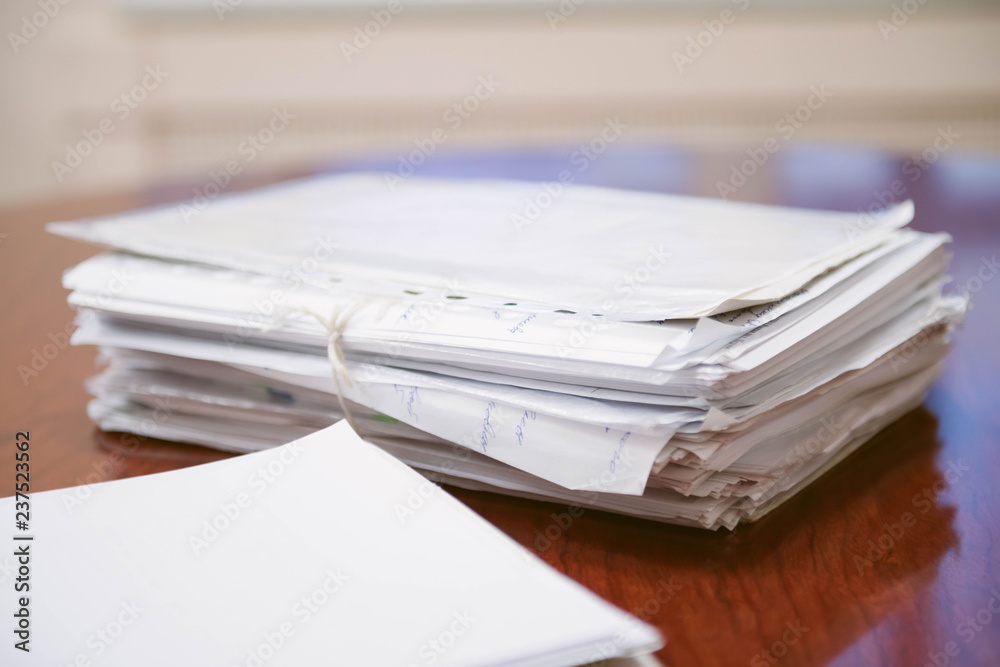 Pile of unfinished documents on office desk, Stack of business paper. A ...
