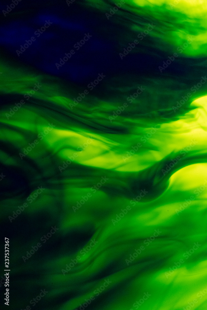 cloud of green and blue ink in a fluid. dispersion of color in a fluid ...