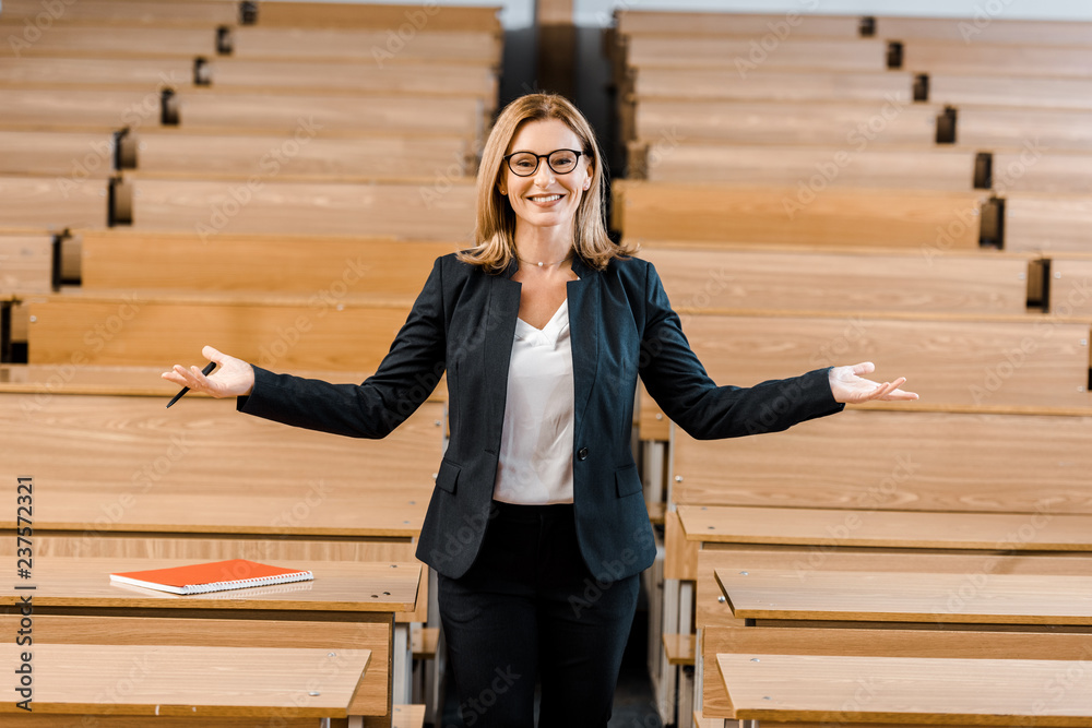 happy female university professor with outstretched hands looking at ...