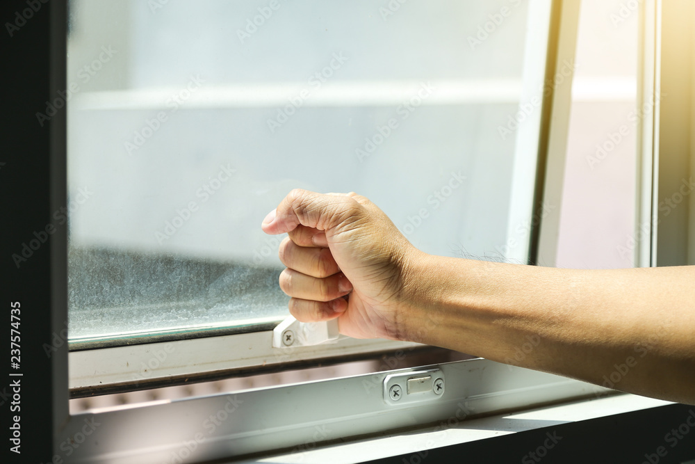 Hand holding glass window latch handle. Stock Photo | Adobe Stock