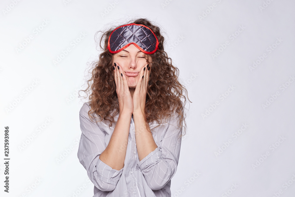 Indoor shot of surprised bugged eyed Caucasian young woman suffers from ...