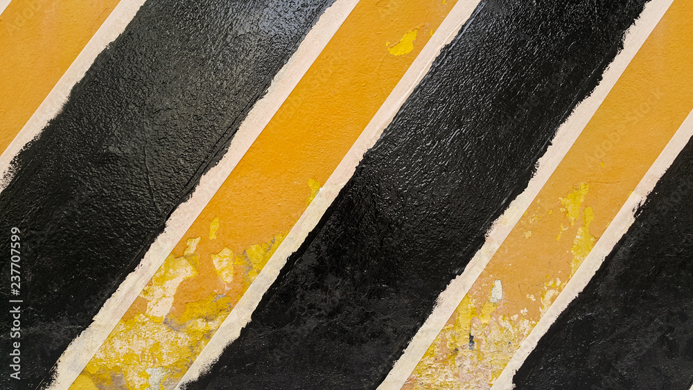 Footpath black and yellow color with brick wall background with free ...