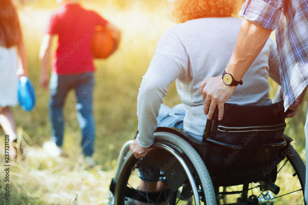 Close up look on woman's back in a wheelchair. Stock Photo | Adobe Stock