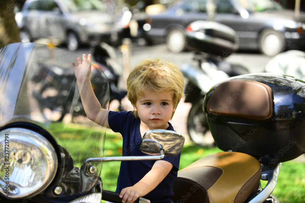 Cute little boy admire of motorbike. Family holiday in other country ...