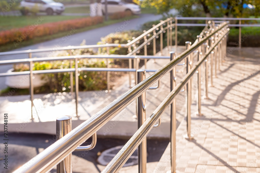 Concret ramp way with stainless steel handrail with disabled sign for ...