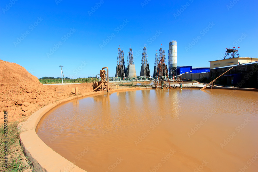 Drilling rig derrick and yellow water in MaCheng iron mine, China Stock ...