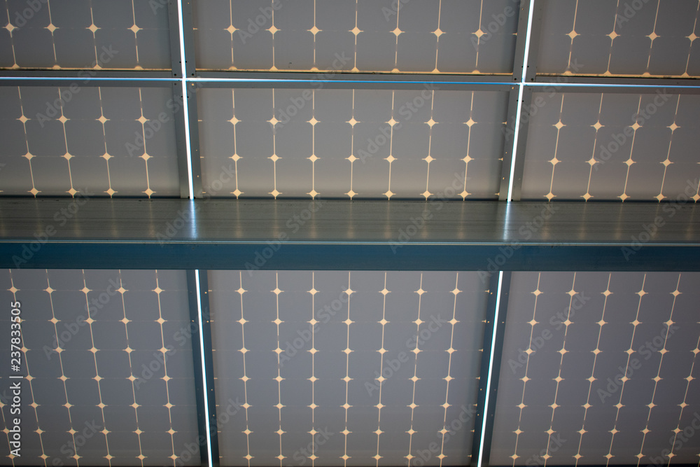Underside of a solar panels installed as solar canopy on top of parking ...