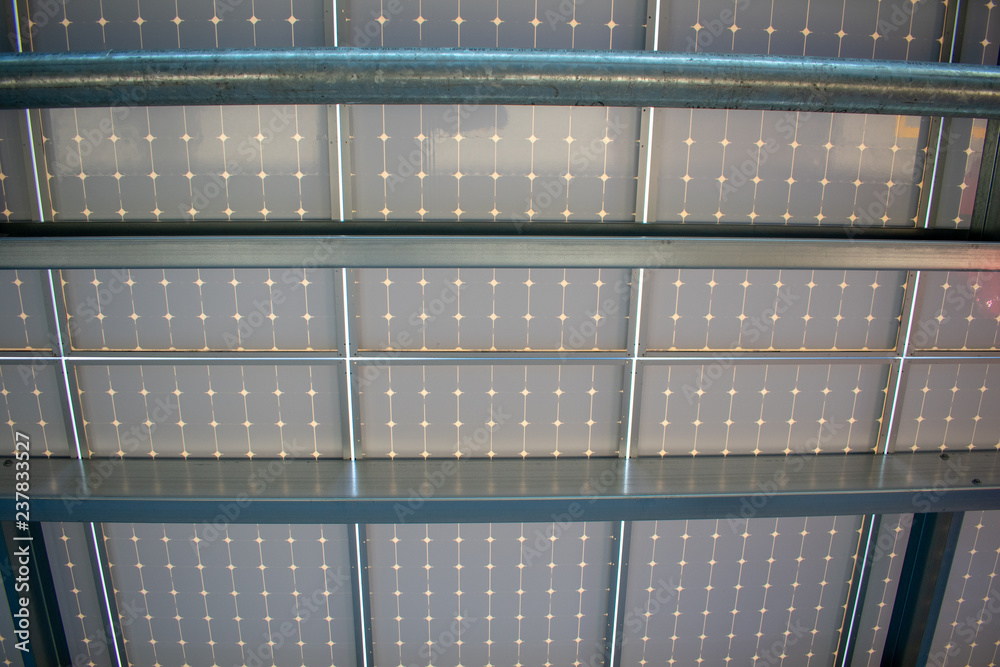 Underside of a solar panels installed as solar canopy on top of parking ...