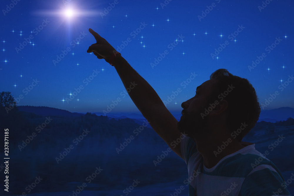 Man pointing at the starry night sky. Elements of this image are my ...