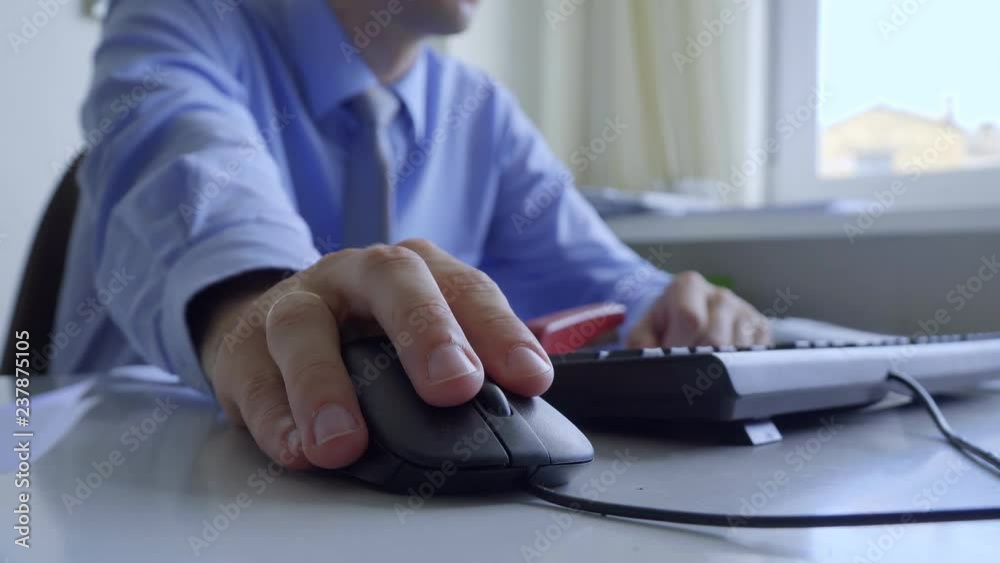The hand of a man who holds an optical mouse. Businessman at work ...