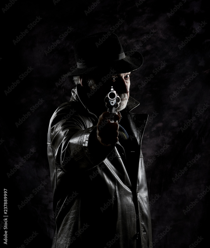 An old private detective armed with a vintage revolver in front of a ...