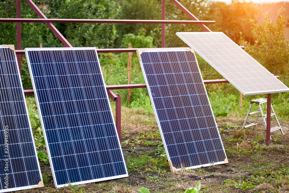 Row of new shiny solar photo voltaic panels arranged outdoors on sunny ...