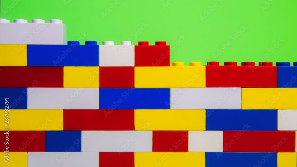 stop motion transition made with a creating blockss wall with green ...