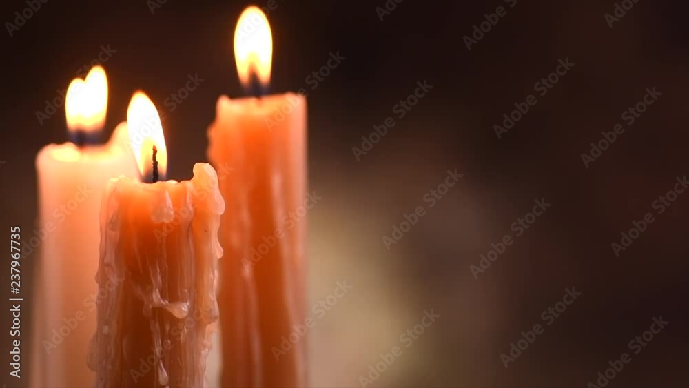 Candle flame closeup on a dark background. Candle light border design ...