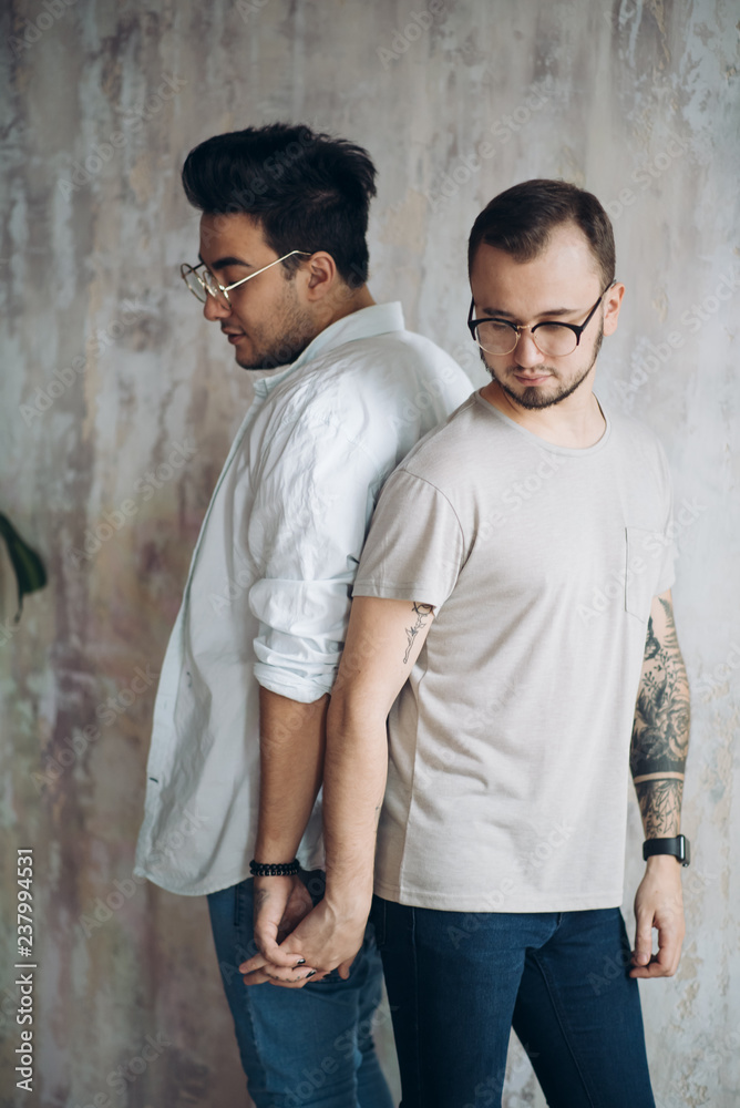 Two Men Standing Back To Back