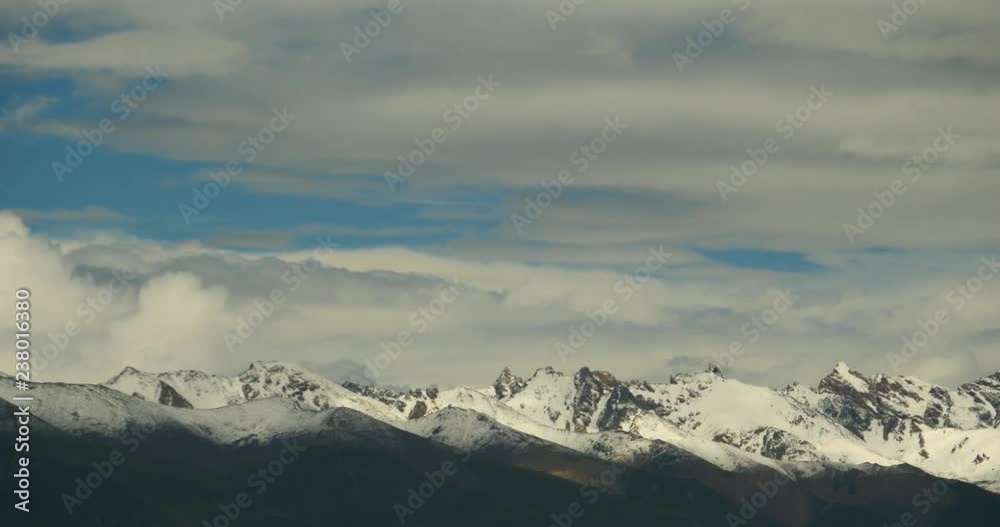 4k dark clouds mass rolling over Tibet snow-Covered mountains,Danggula ...