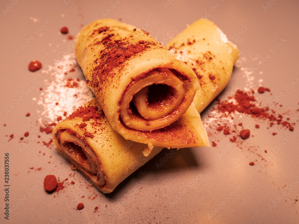 Self made pan cakes in rolled and cut condition with poweder suger ...