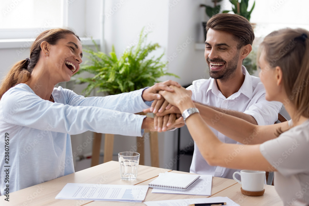 Diverse millennial motivated businesspeople happy satisfied coworkers ...