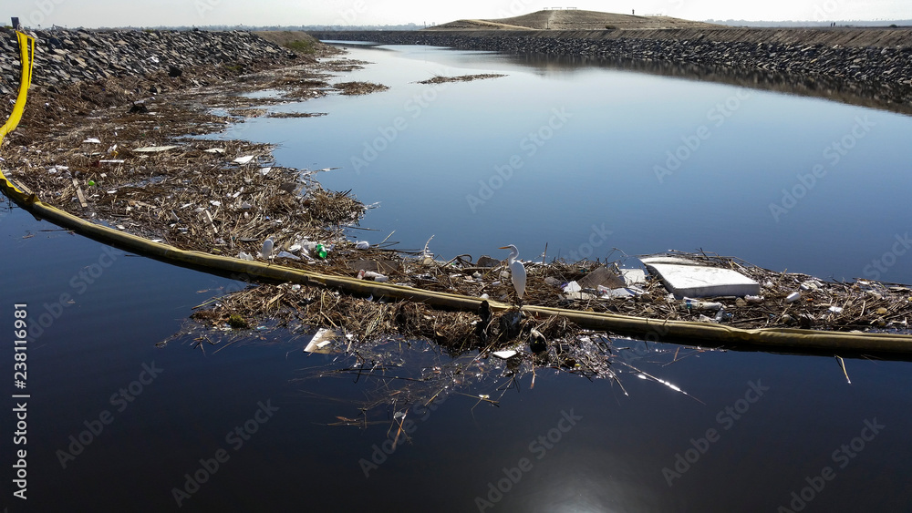 Inflatable floating yellow pipe stopping accumulated drifting trash ...
