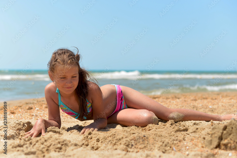 Teenage girl lying on the sandy beach on a hot summer day Stock Photo ... Teenage girl lying on the sandy beach on a hot summer day Stock Photo ...